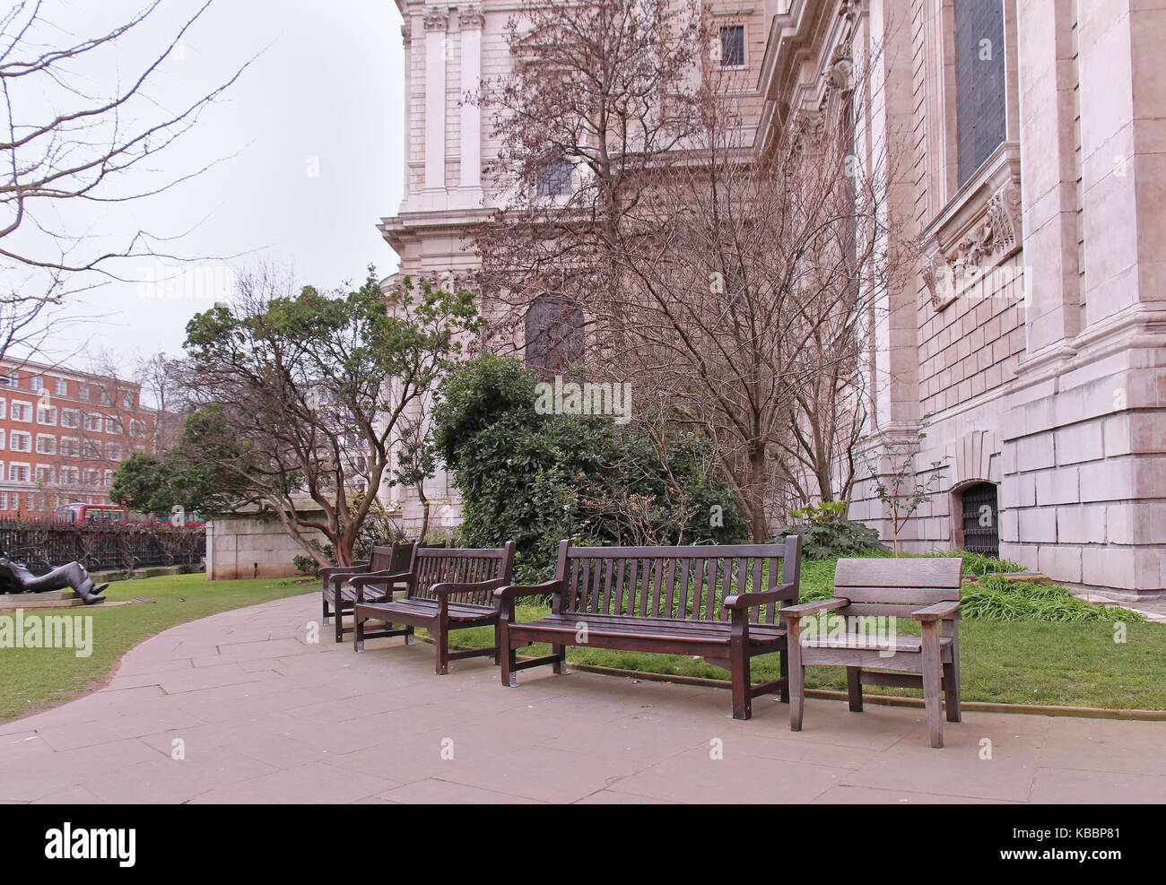 Wooden benches outside in urban city park Stock Photo - Alamy