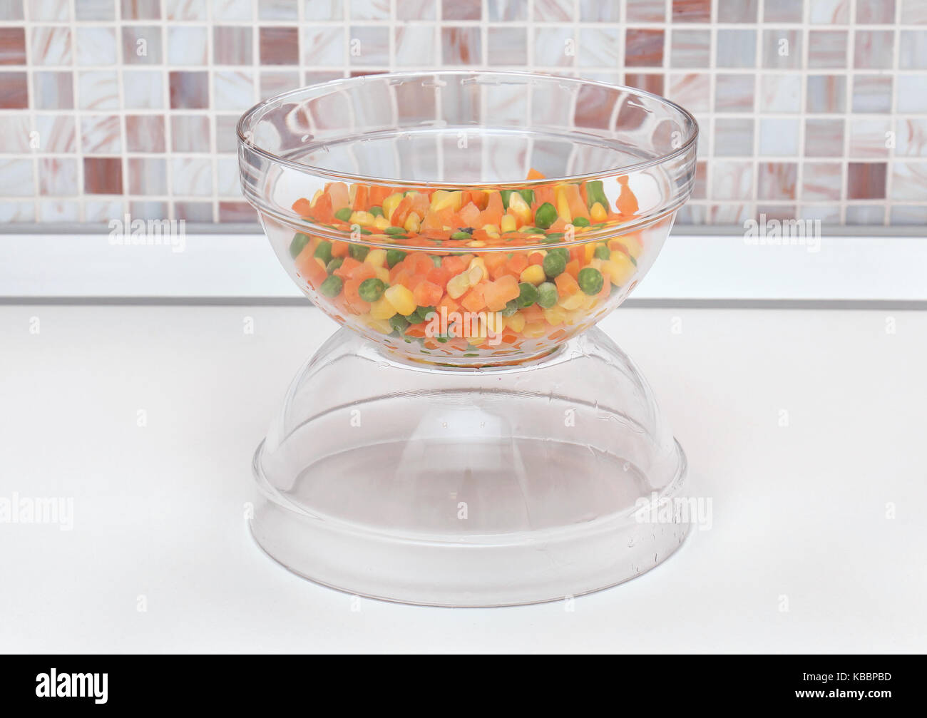 Transparent glass bowl with colorful vegetables inside Stock Photo - Alamy