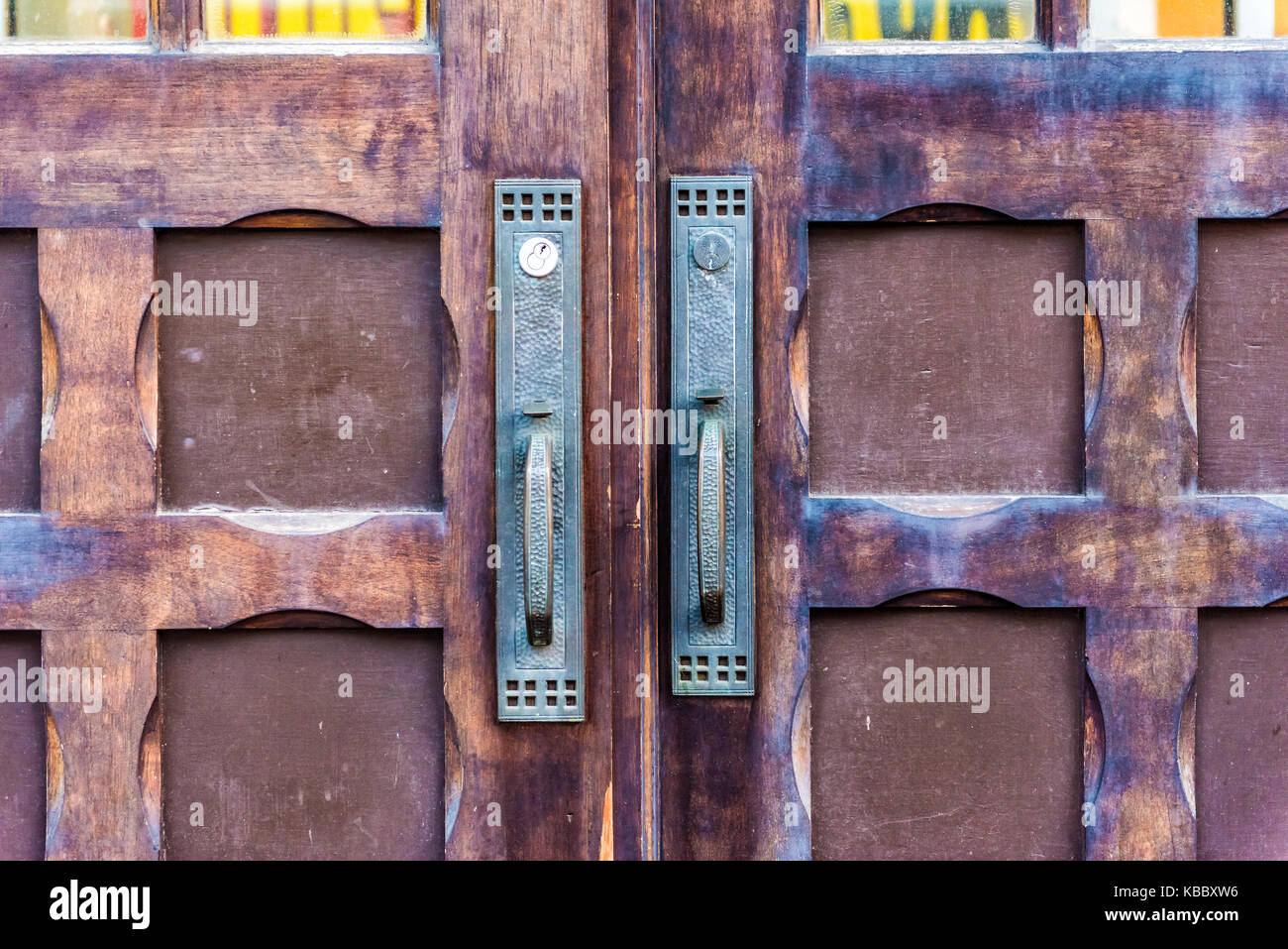 Closeup of vintage wooden door handles showing symmetry, pattern and ...