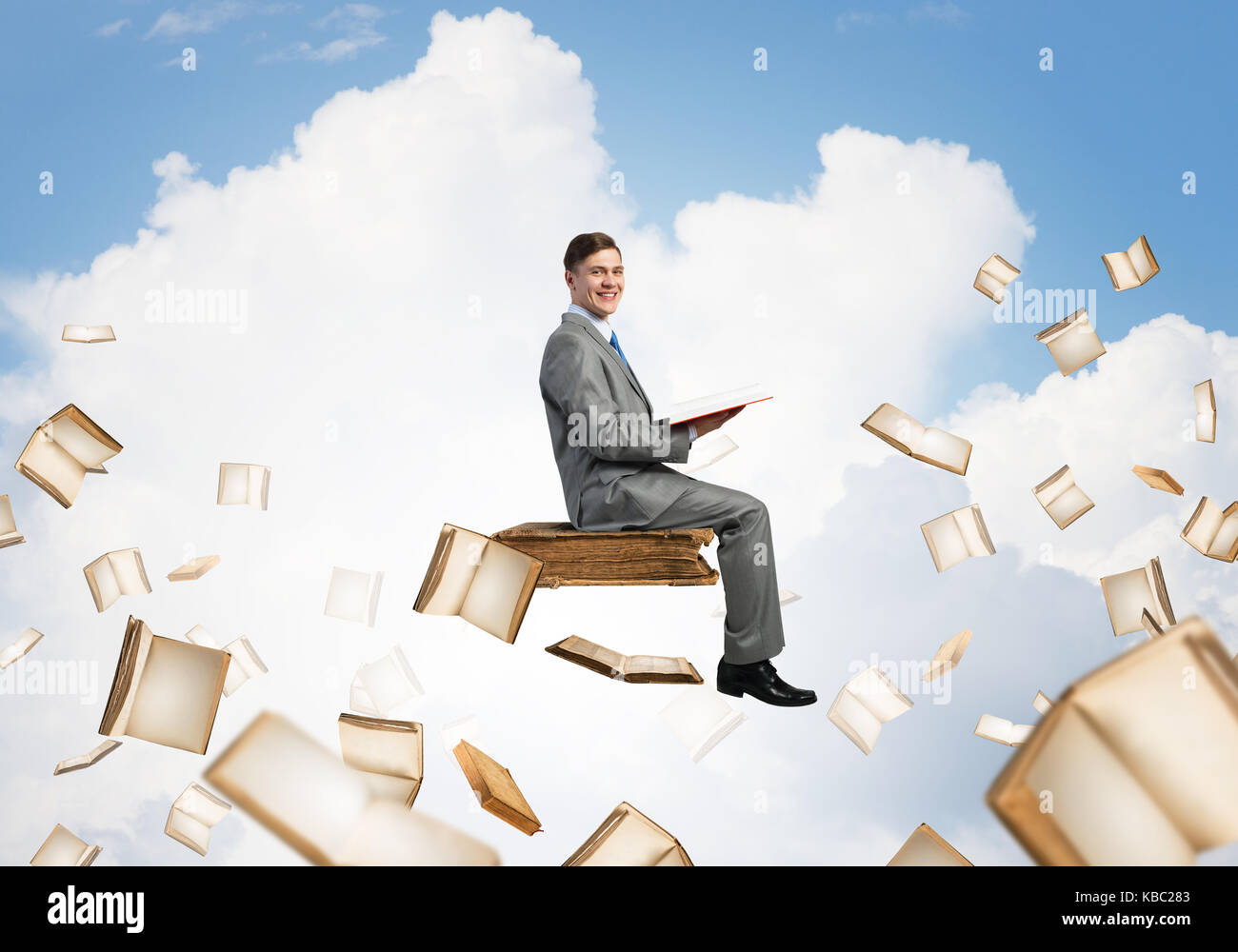 Man reading book and many of them flying in air Stock Photo - Alamy