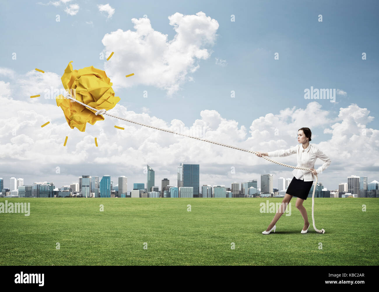 Businesswoman pulling paper ball with rope and making it raise up Stock ...