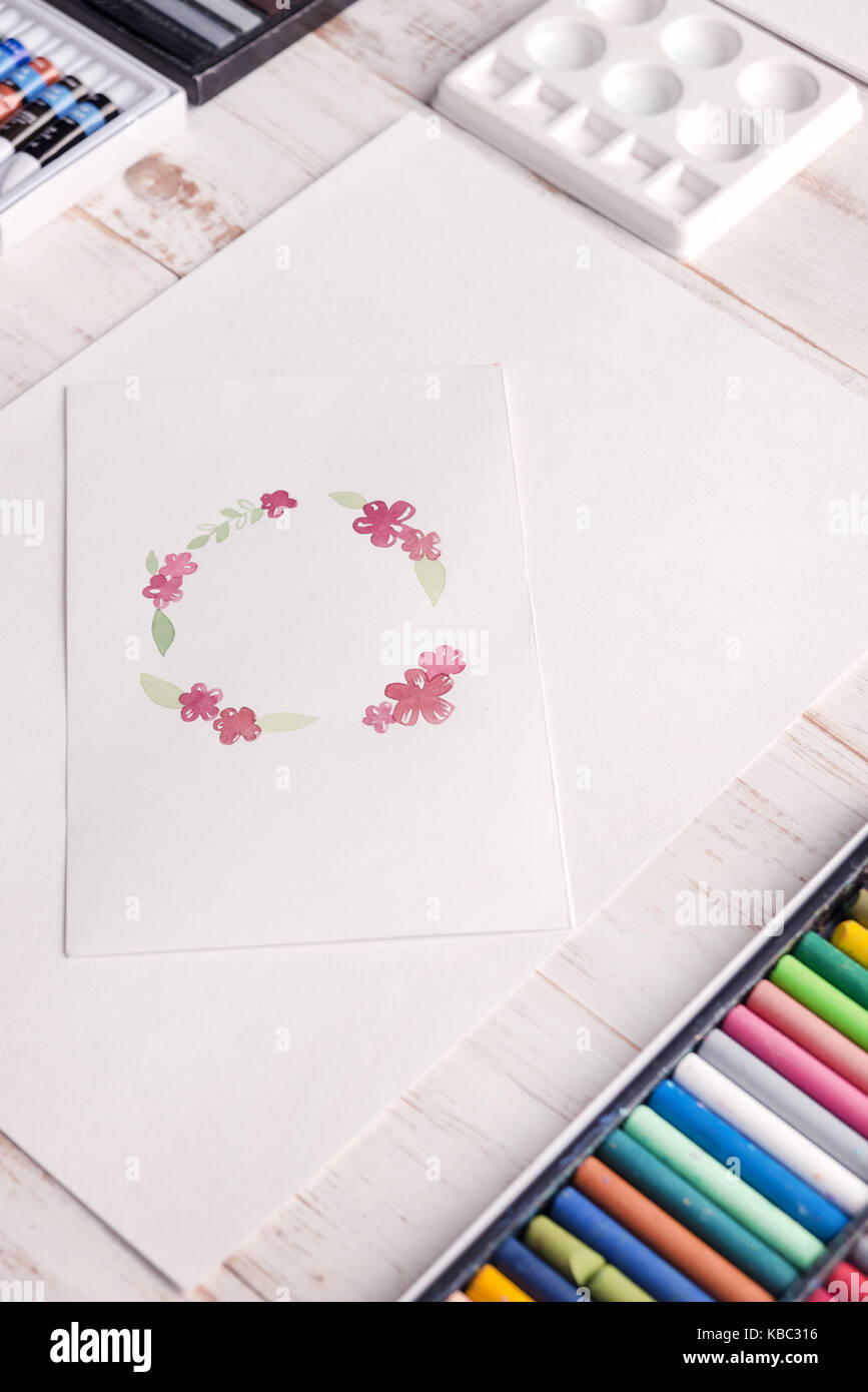 Flowers frame painted with watercolors on paper. Artist equipment on ...