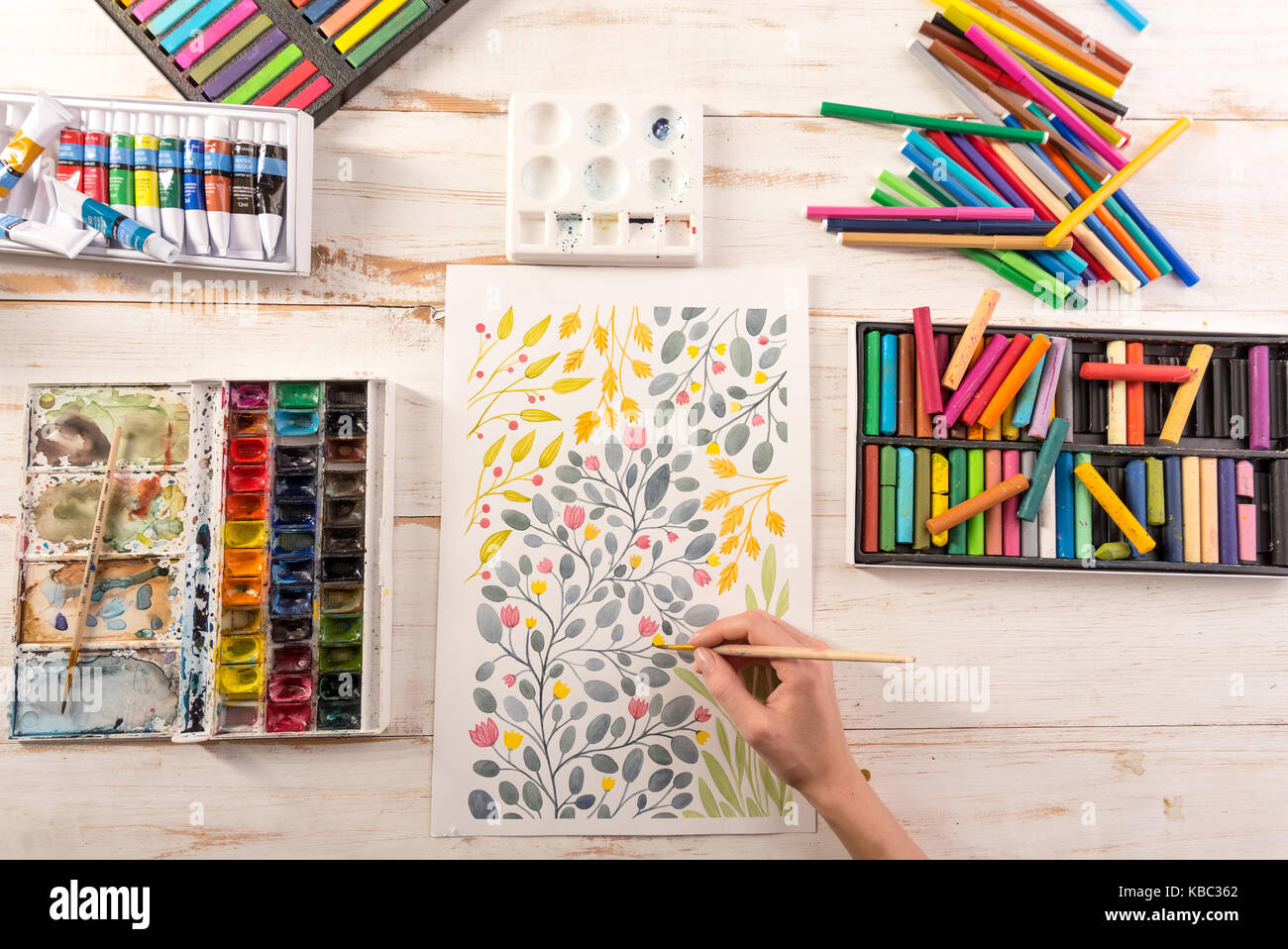 Top view of artist drawing colorful flowers design at workplace. Artist ...