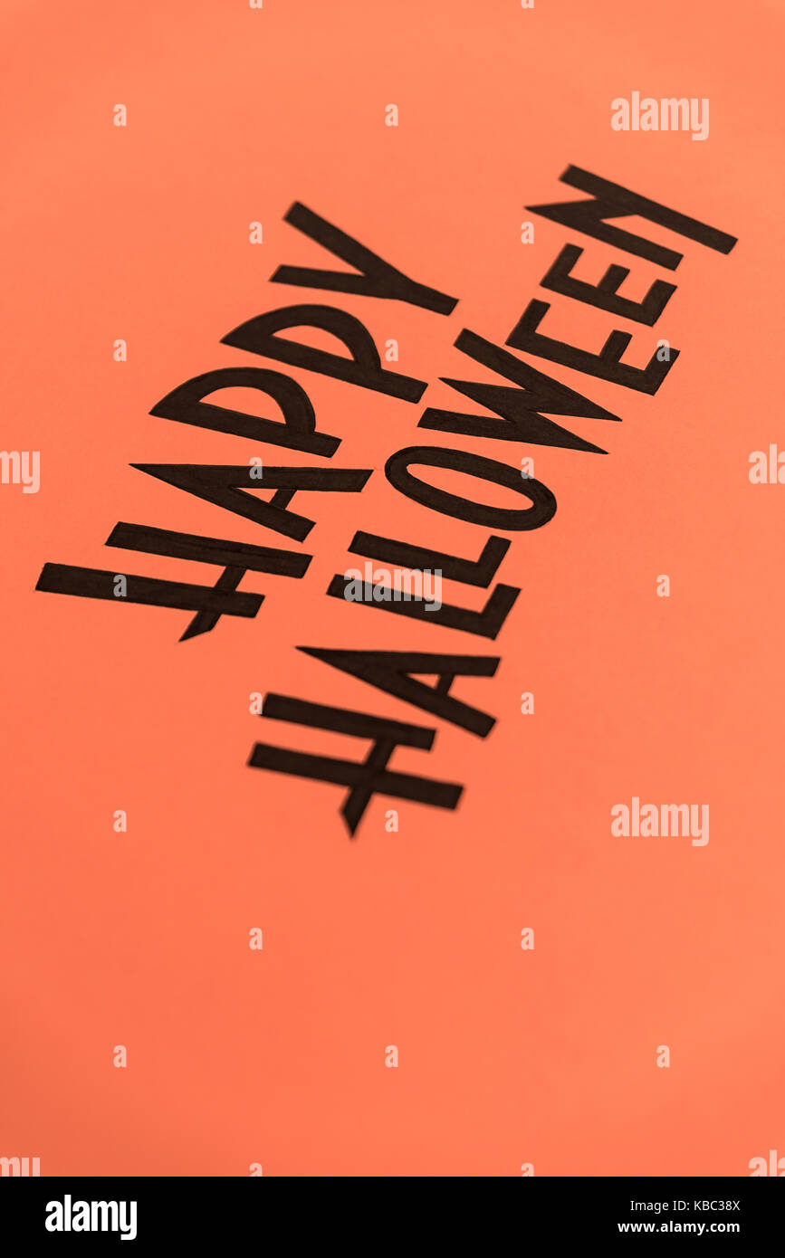 Black typeface text for halloween logo handwritten on orange background ...