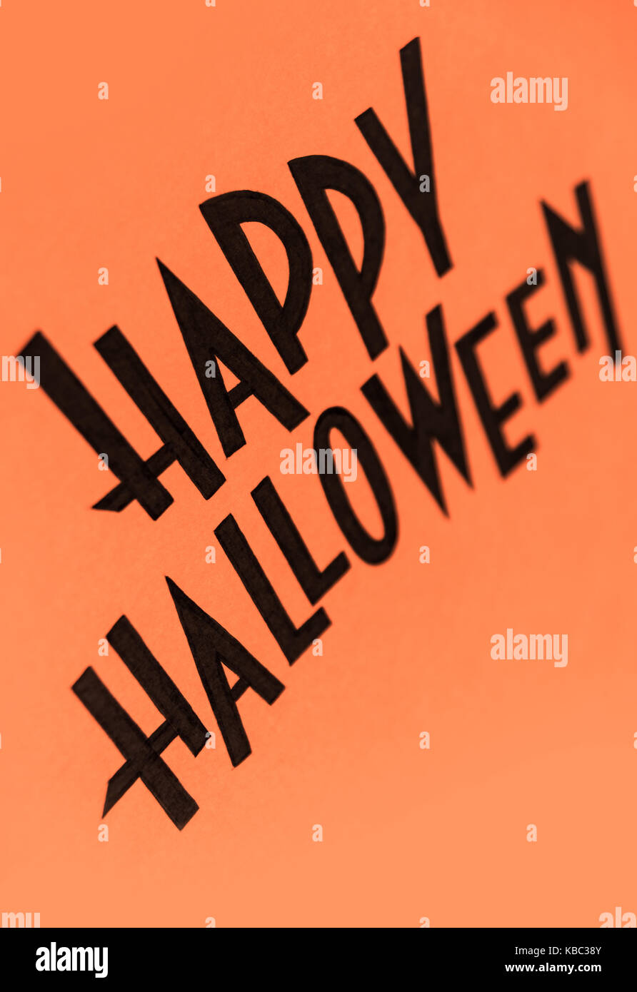 Black typeface text for halloween logo handwritten on orange background ...