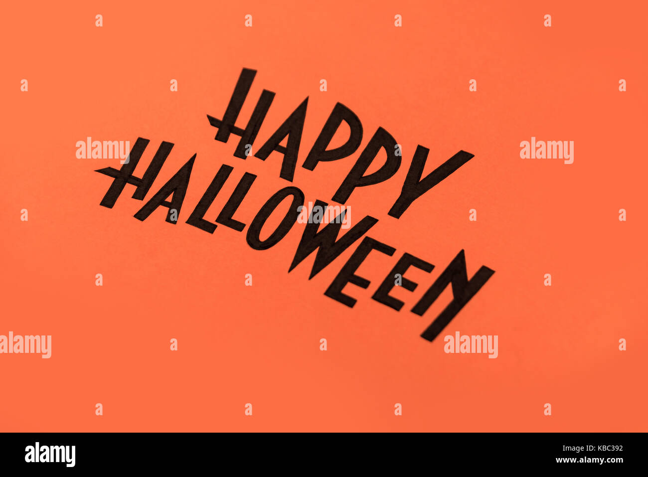 Black typeface text for halloween logo handwritten on orange background ...