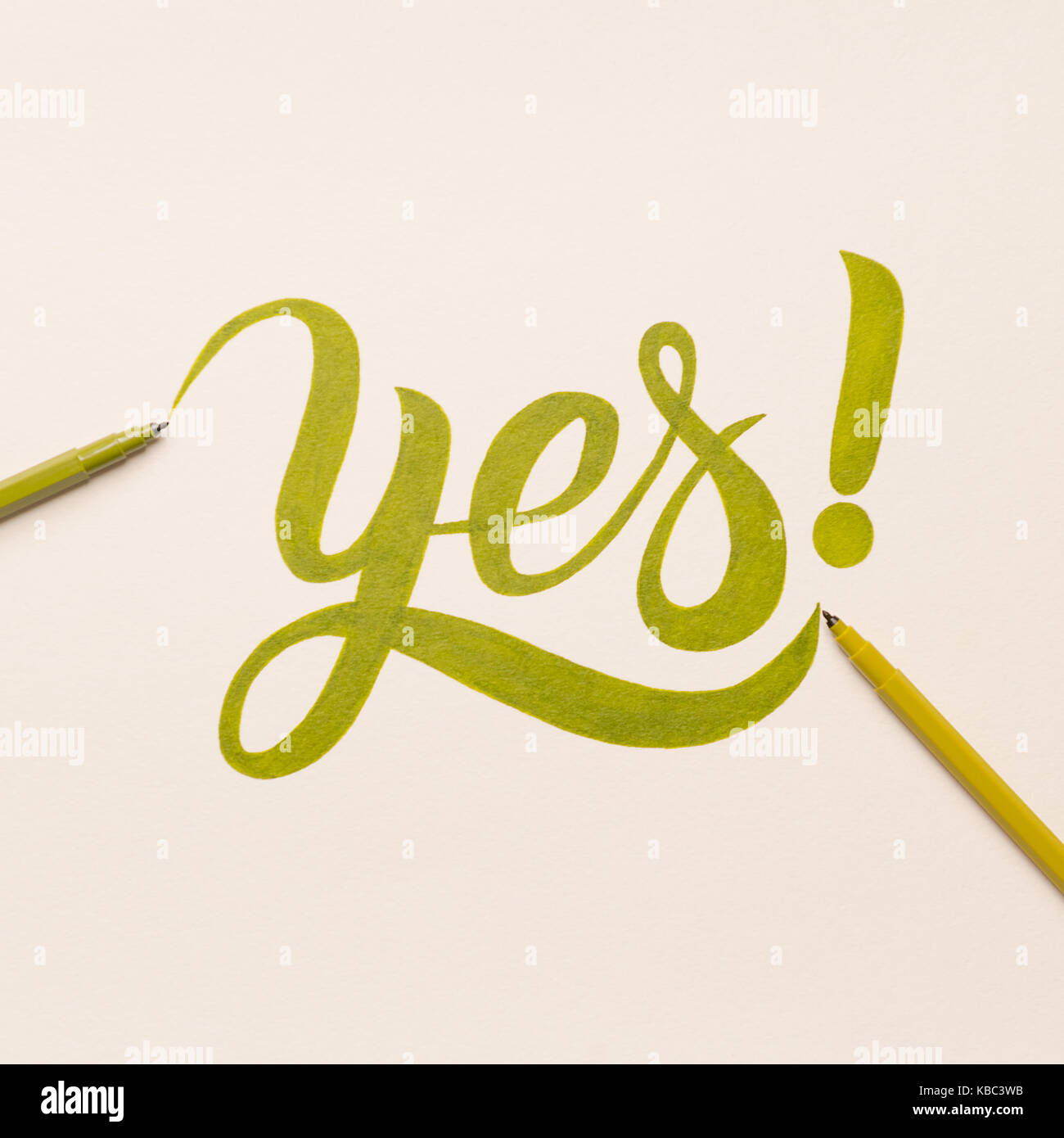 Green hand drawing phrase YES on white sheet with green markers Stock ...