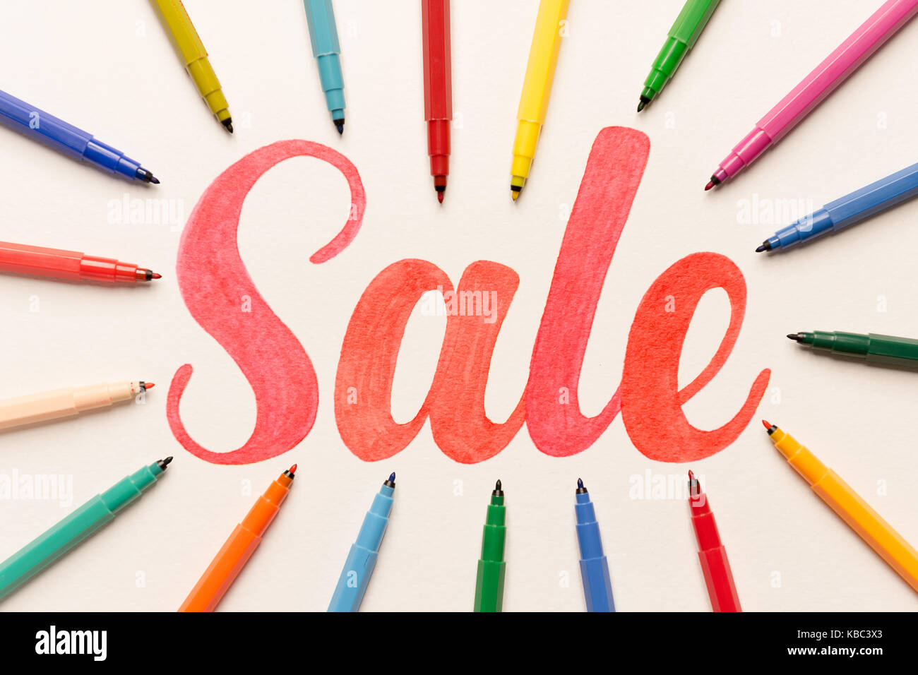 Red hand written calligraphy lettering 'Sale' in bunch of colorful ...