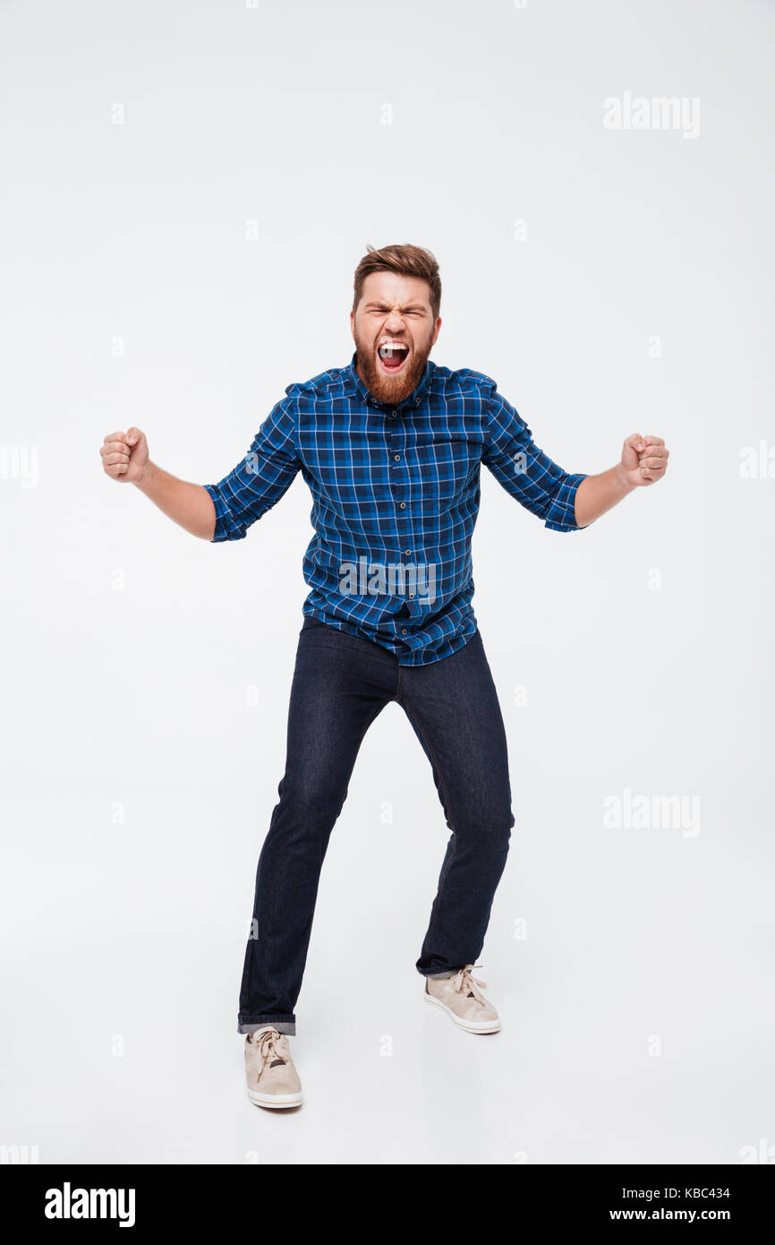 Full length portrait of a crazy bearded man screaming and gesturing ...