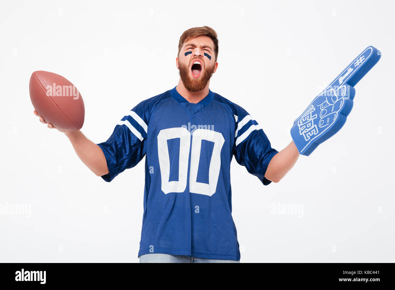Excited screaming bearded man in blue t-shirt with rugby ball and fan ...