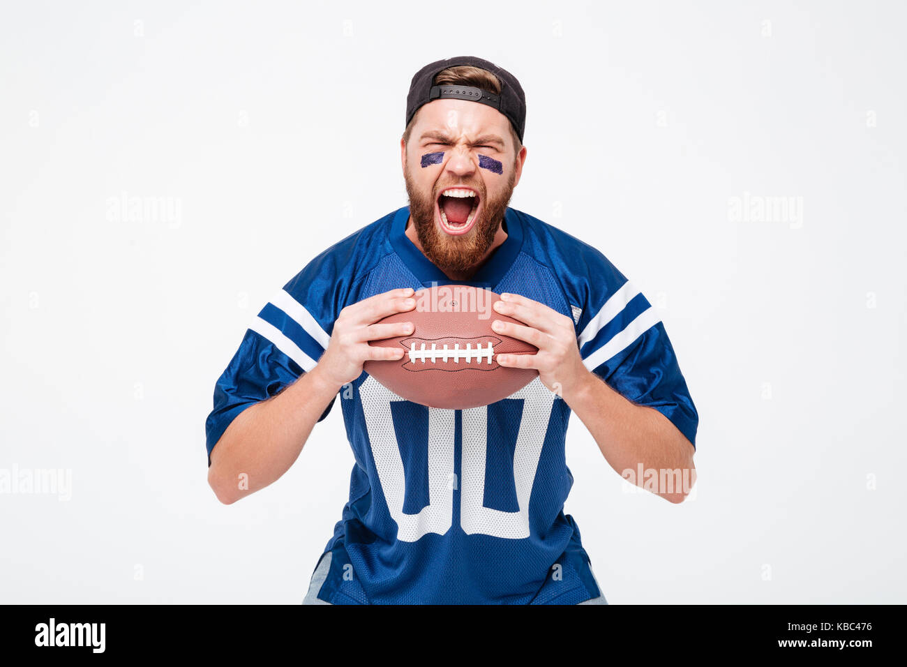 Image of excited screaming man fan in blue t-shirt standing isolated ...
