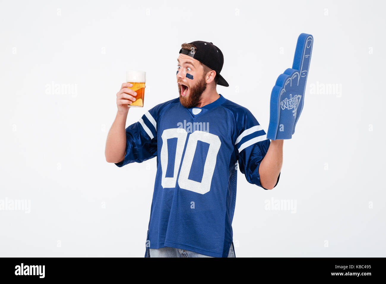 Picture of emotional man fan in blue t-shirt wearing fan finger number ...