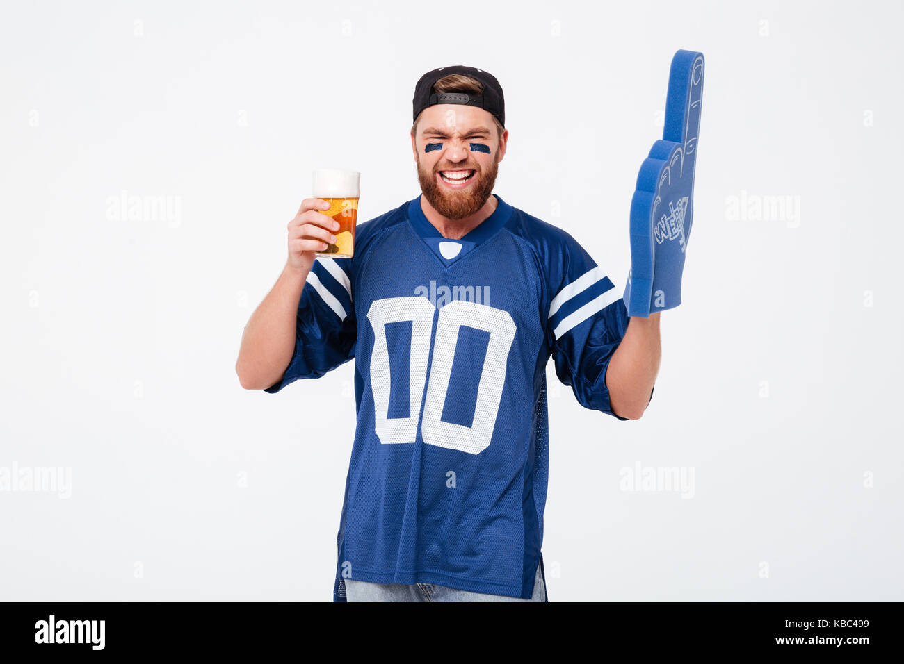 Photo of emotional man fan in blue t-shirt wearing fan finger number ...