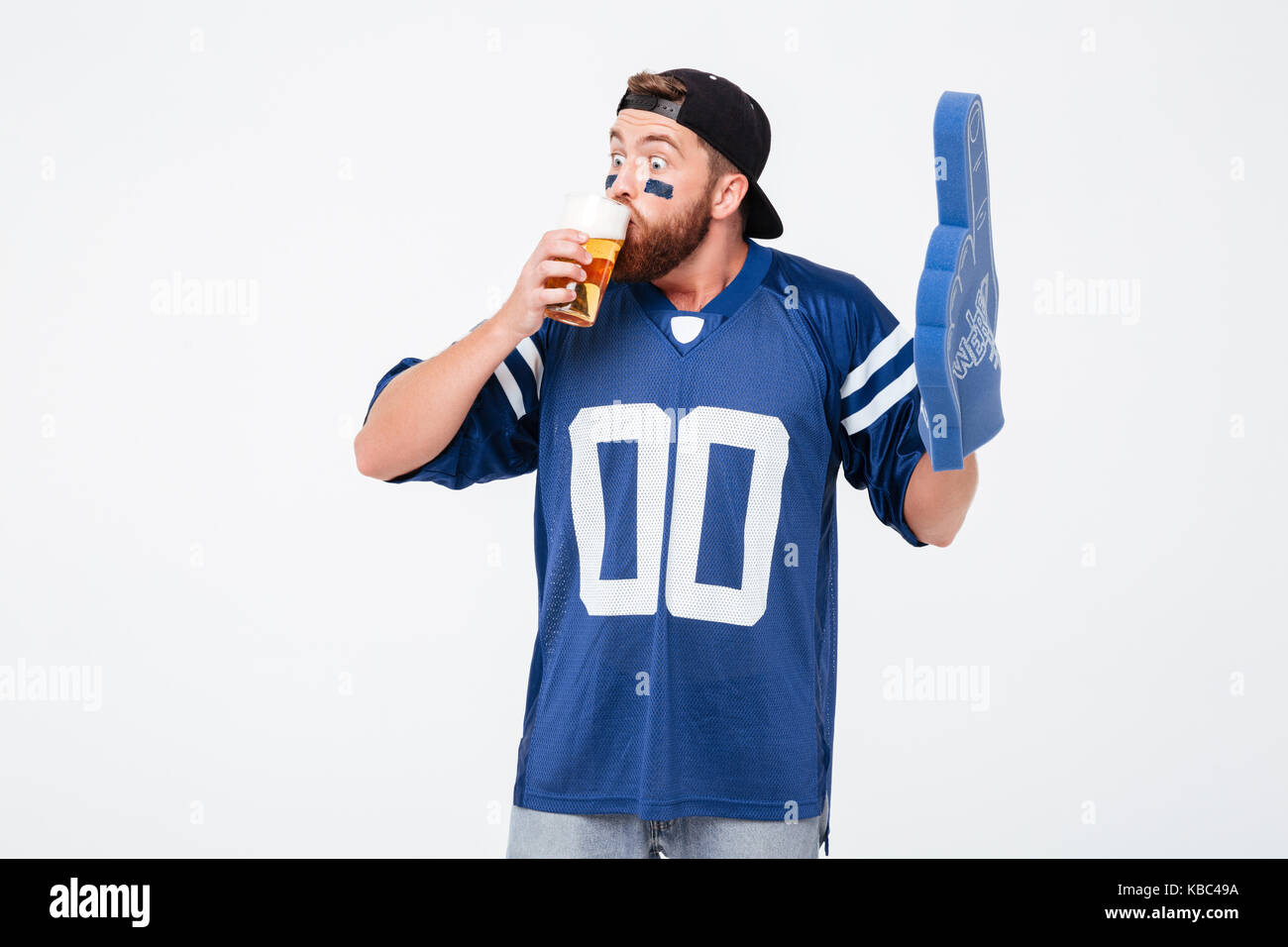 Image of handsome man fan in blue t-shirt wearing fan finger number one ...