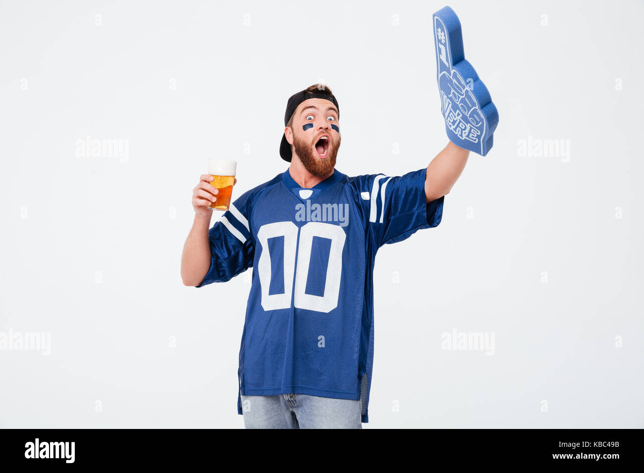 Picture of emotional man fan in blue t-shirt wearing fan finger number ...