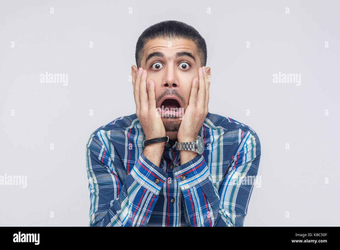 Human face expressions and emotions. Man holding arms on her cheeks ...