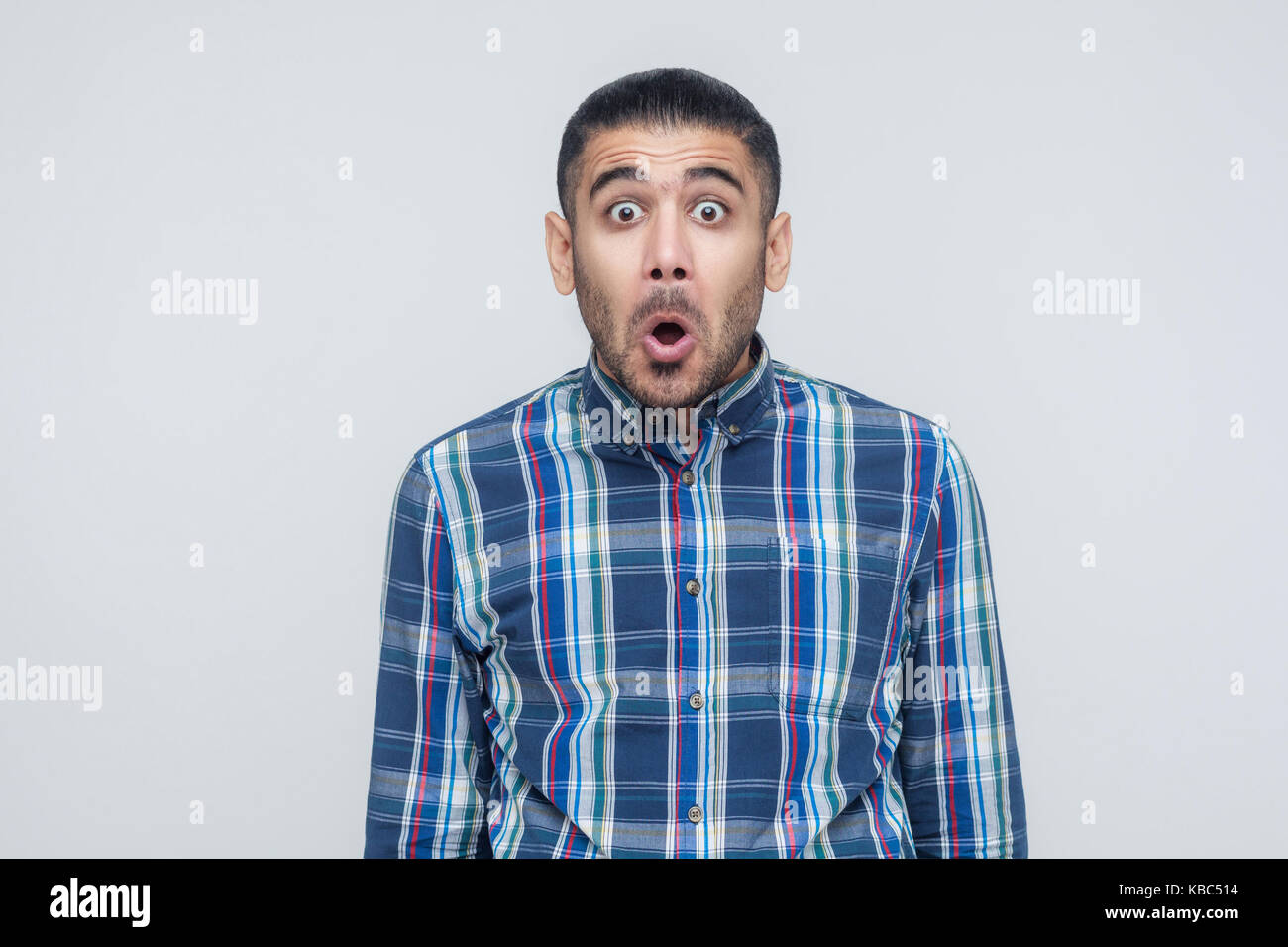 Man opened mouth and scream. Have a shocked face and big eyes. Studio ...