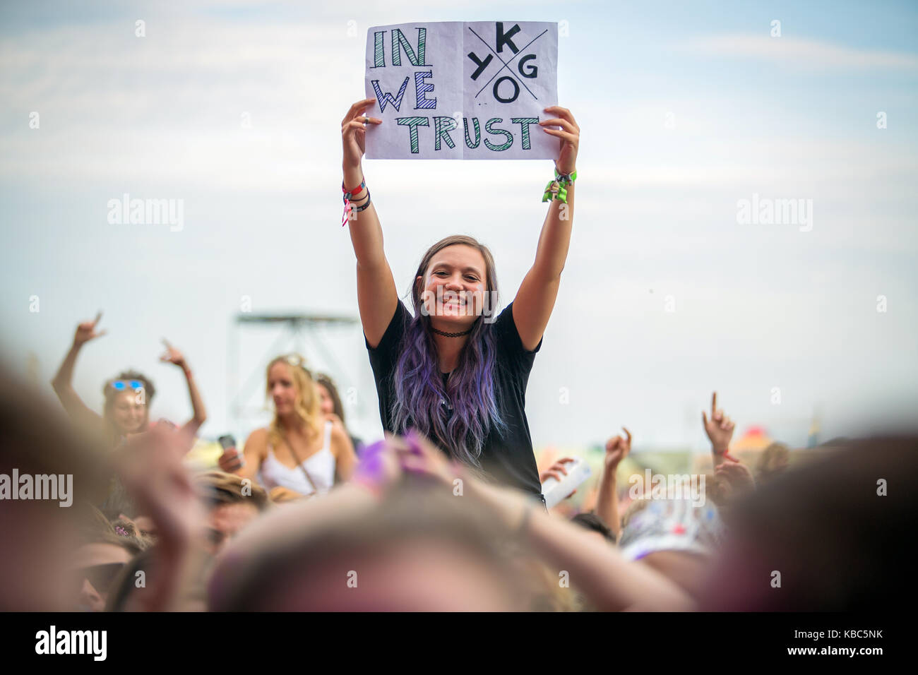 Enthusiastic and energetic music fans go crazy at a concert with the ...