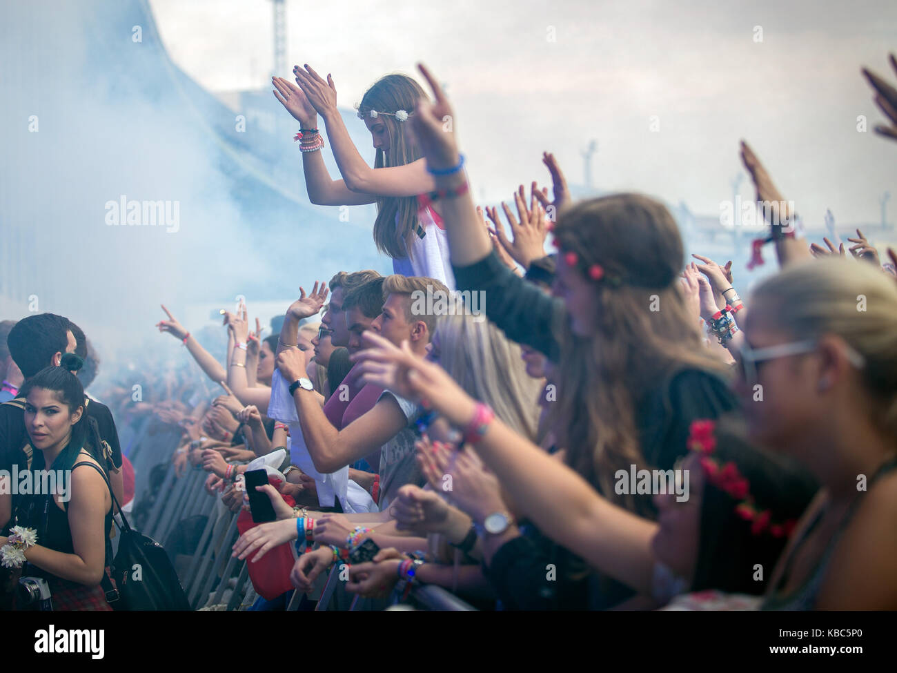 Enthusiastic and energetic music fans go crazy at a concert with the ...