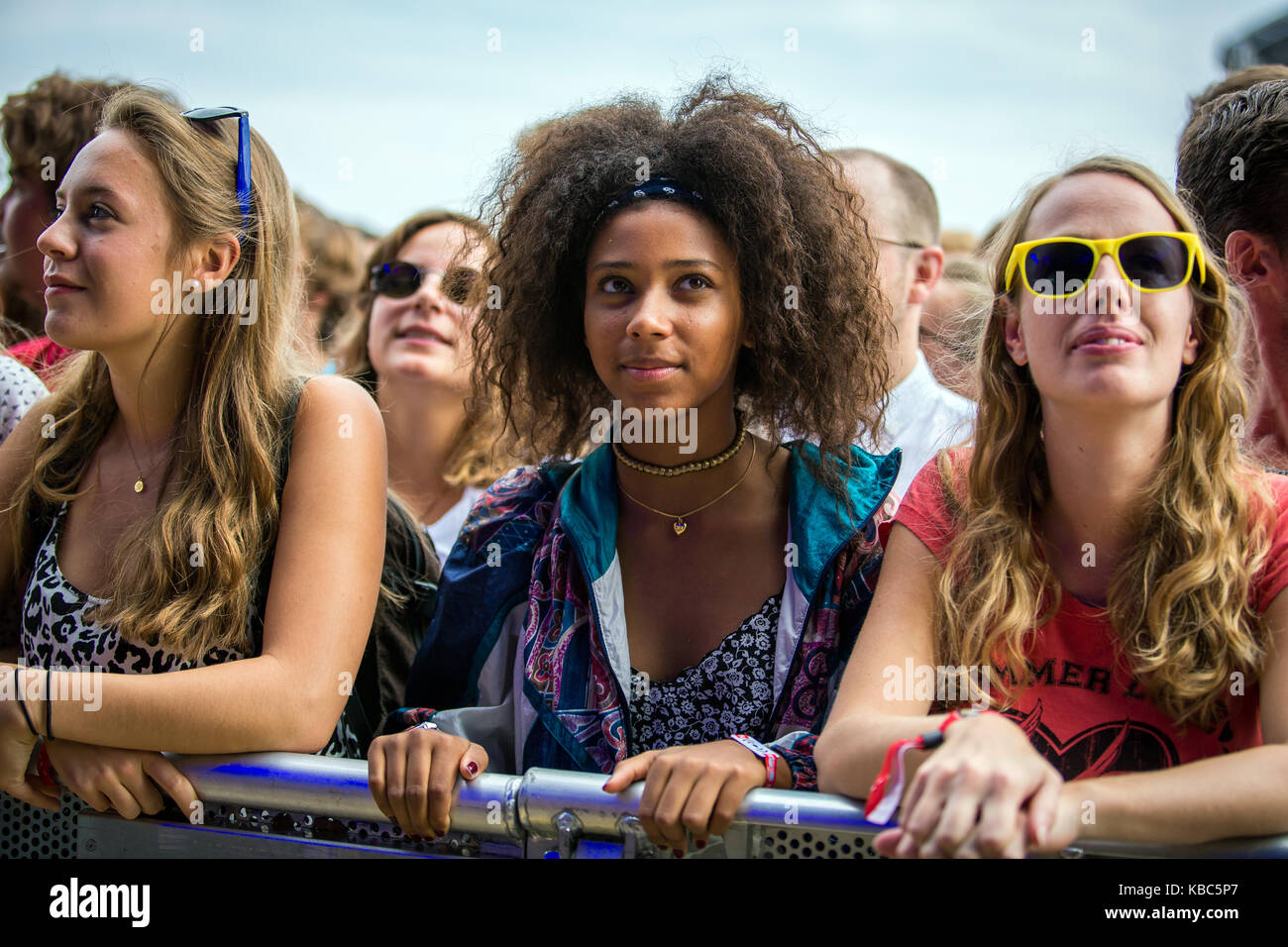 Enthusiastic and energetic music fans attend a concert with the ...