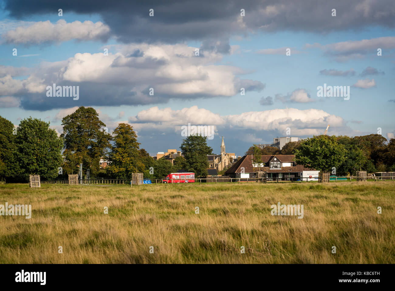 Grassland in Bushy Park and view of St John's Church in Hampton Wick ...