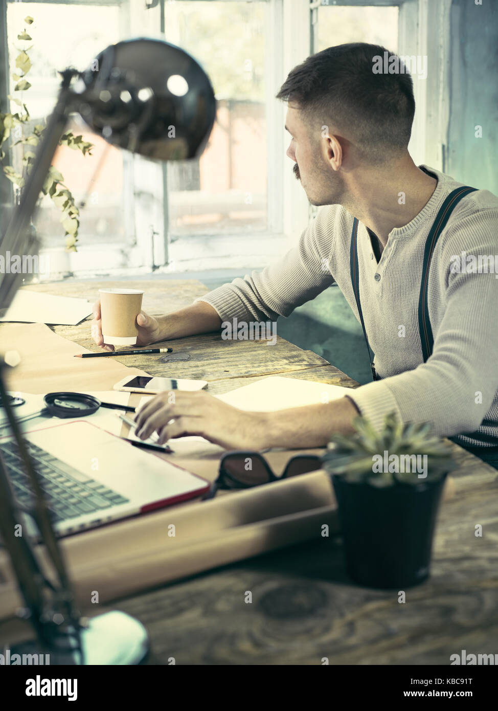 Architect working on drawing table in office Stock Photo - Alamy