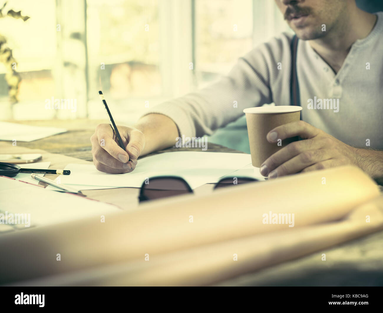 Architect working on drawing table in office or home. Studio shot Stock ...