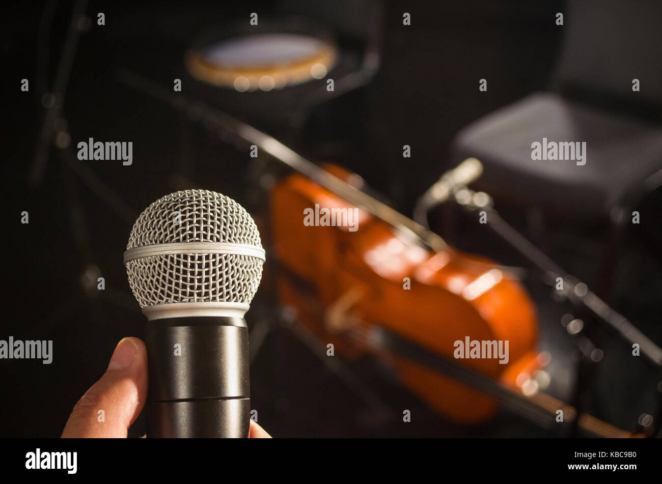 Audio microphone and blur musical instrument background Stock Photo - Alamy