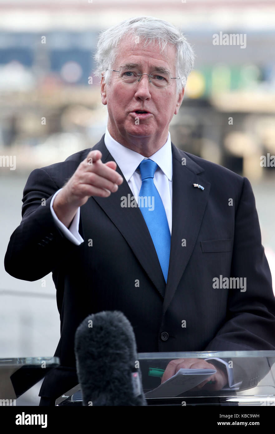 Defence Secretary Sir Michael Fallon speaks to the media alongside the ...