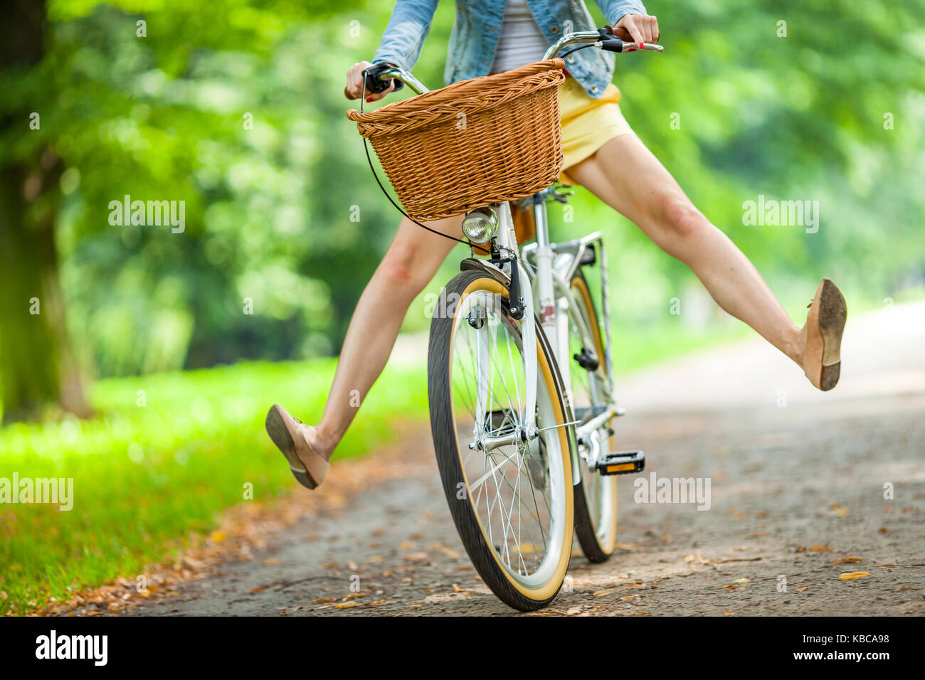 Woman riding bicycle with her legs in the air Stock Photo - Alamy