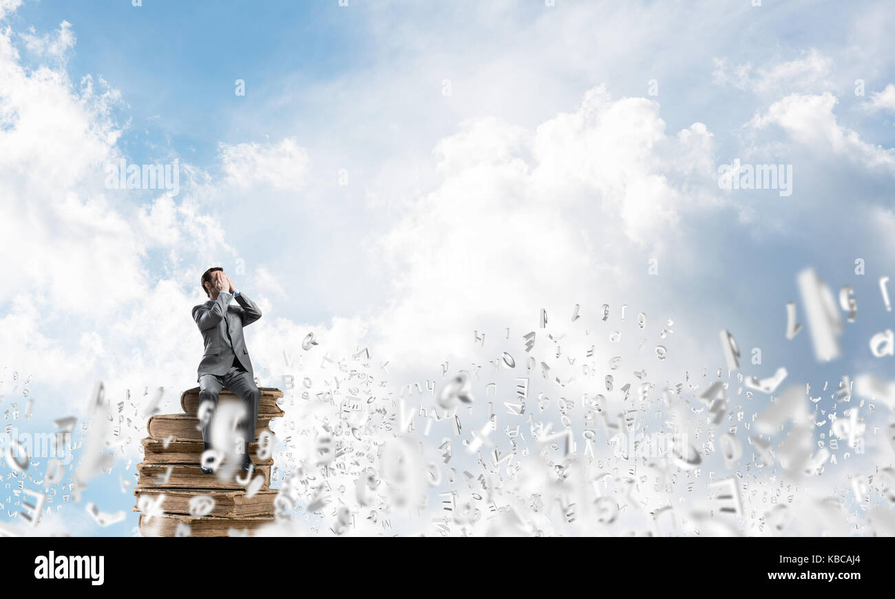 Young man floating in sky and do not want to see anything Stock Photo ...