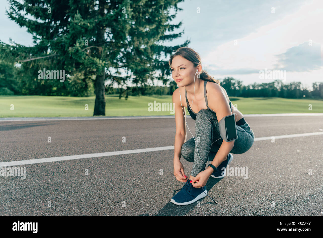 woman tying shoelaces Stock Photo - Alamy