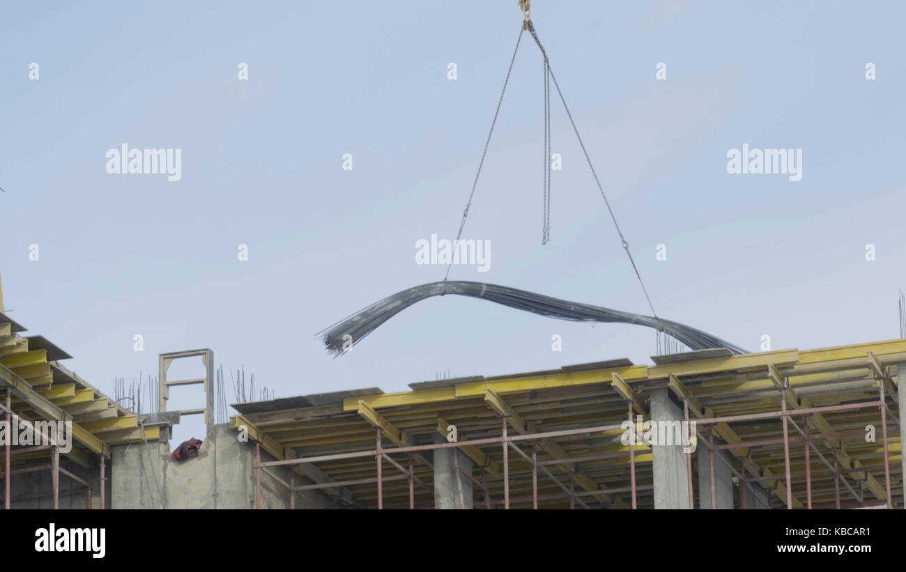 Crane works pipes unloading. Working crane lifts the pipe Stock Photo ...