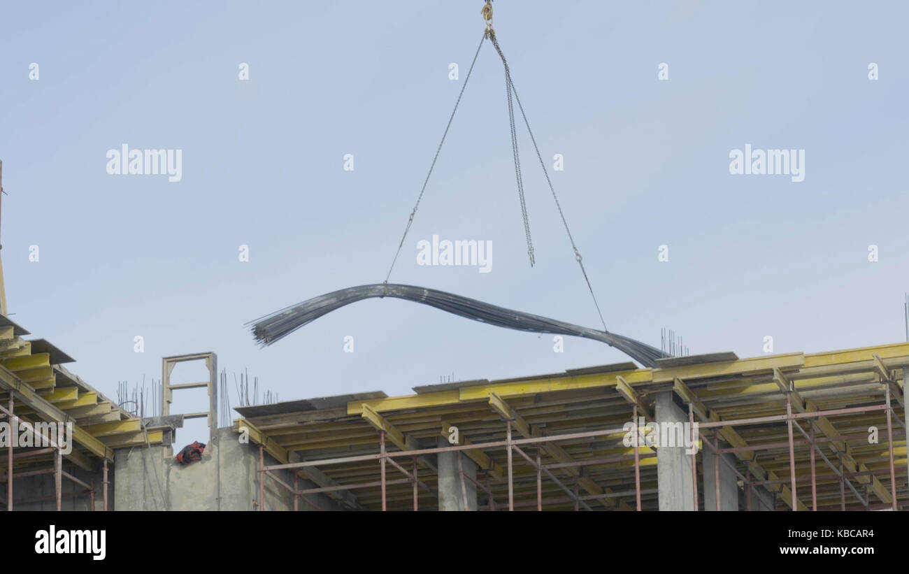 Crane works pipes unloading. Working crane lifts the pipe Stock Photo ...