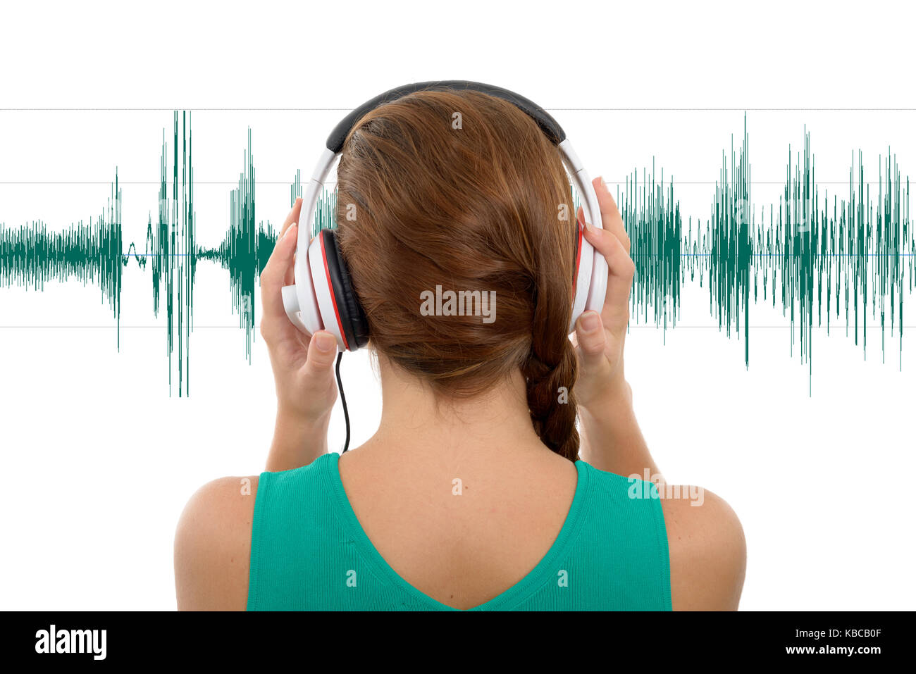 a young woman listenning music with headphone, back view, on white ...