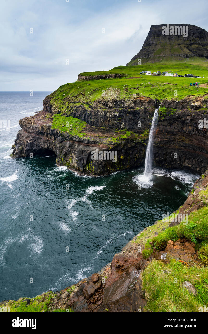 Gasadalur waterfall into the ocean, Vagar, Faroe Islands, Denmark ...