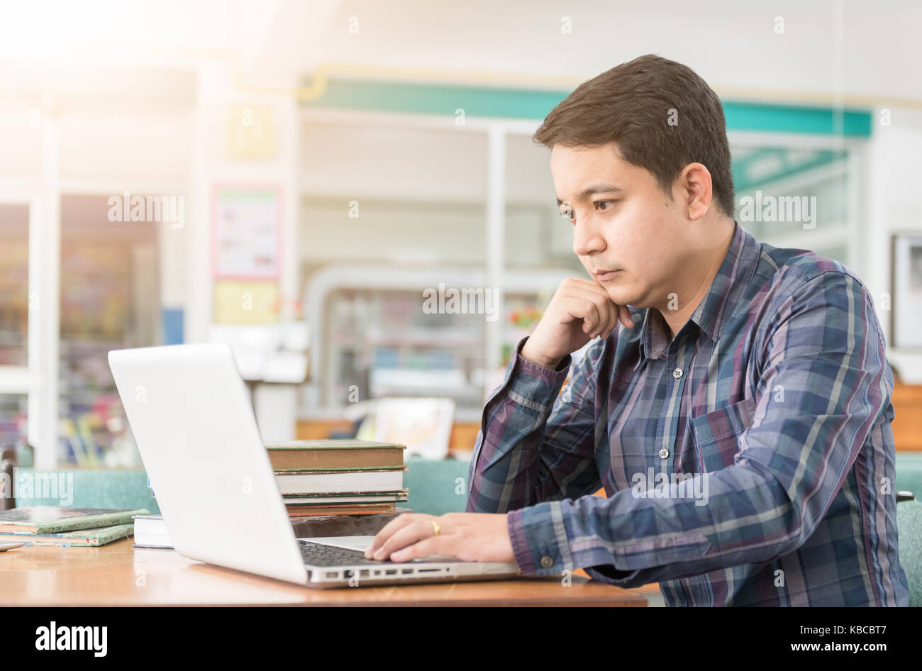 young student play computer and preparing exam and learning lessons in ...