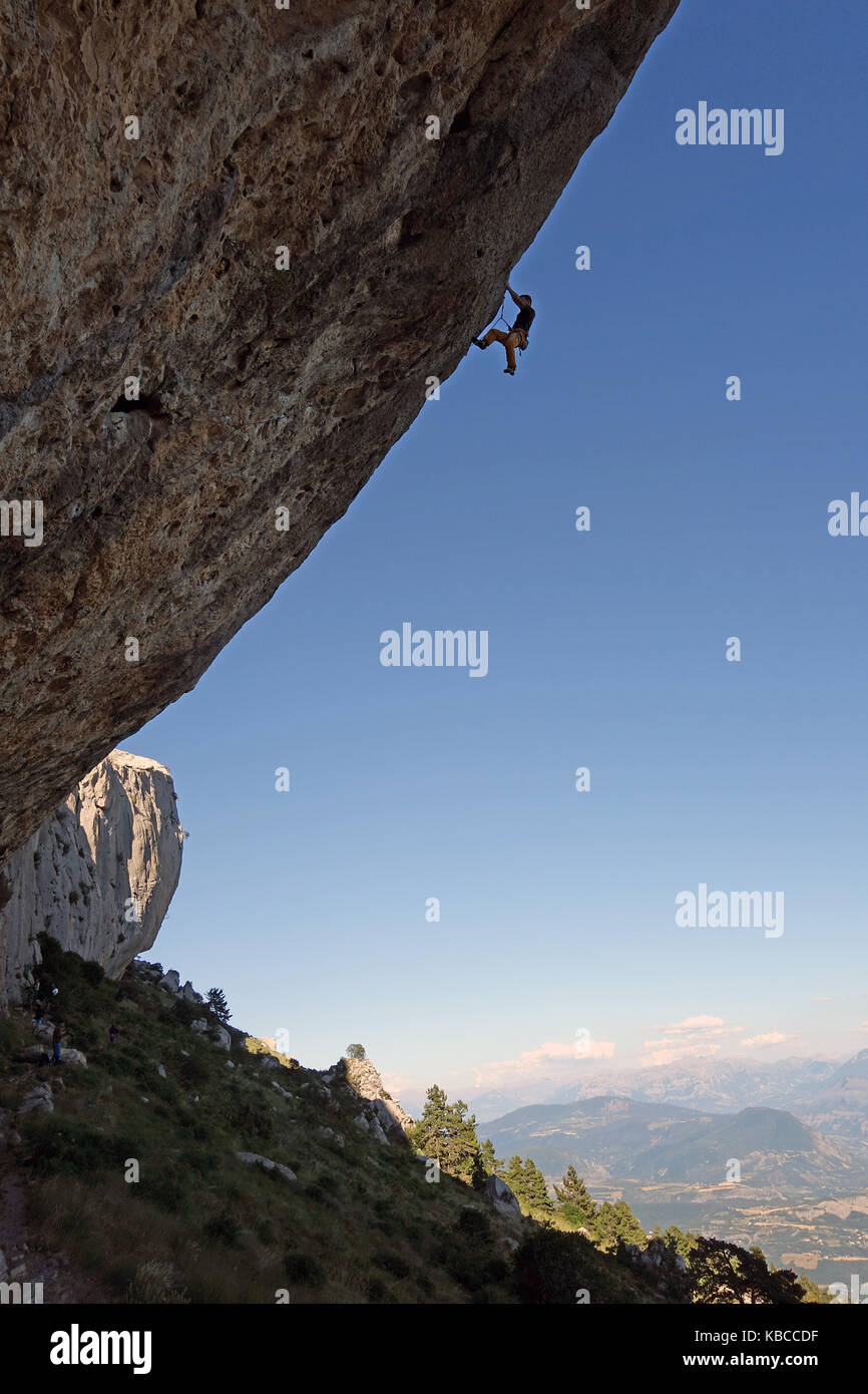 A climber ascends a difficult route on the cliffs of Ceuse, a mountain ...