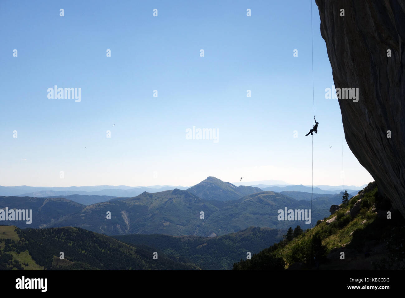 A climber ascends a rope on the cliffs of Ceuse, a mountain in the ...