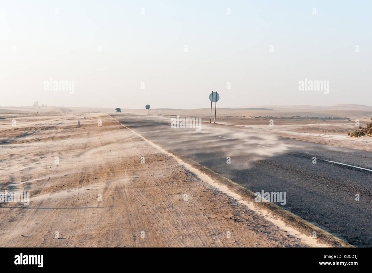 Sand being blown over the B2-Road near Longbeach in the Namib Desert on ...