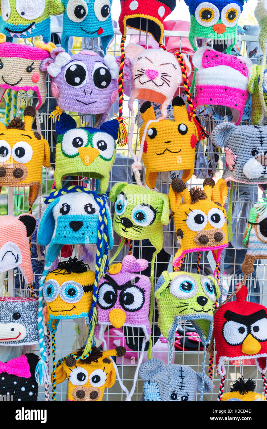 Showcase of many funny winter hats with ears and eyes Stock Photo - Alamy