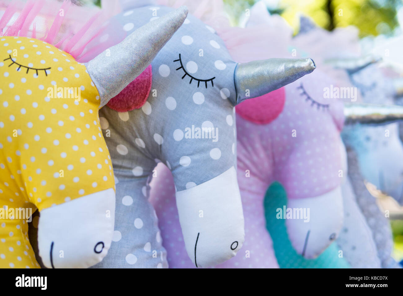 Shop showcase of the soft toy unicorn - pillows, lined up in a row ...
