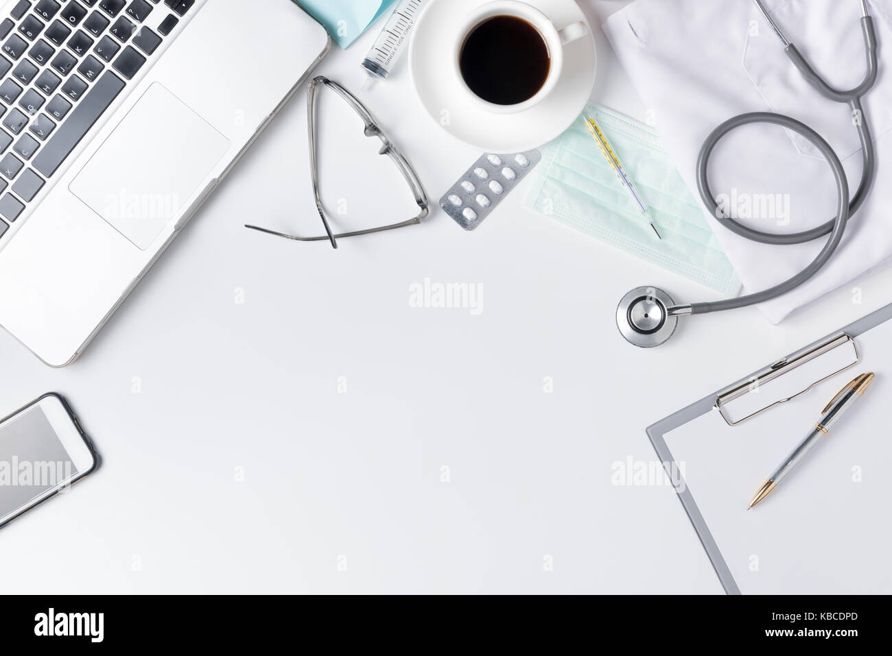 Top view of doctor desk table with stethoscope, coffee, Medical gown ...