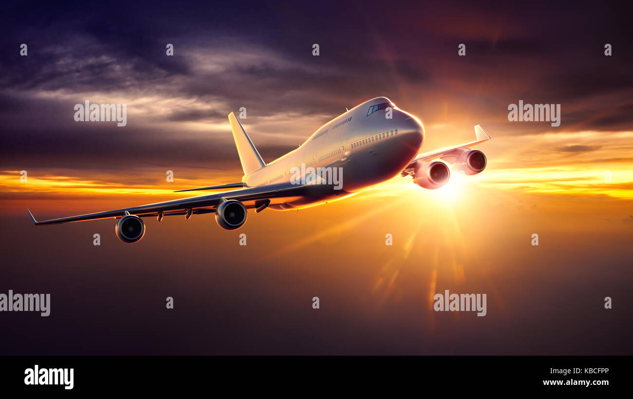 Airplane flying during sunset Stock Photo - Alamy