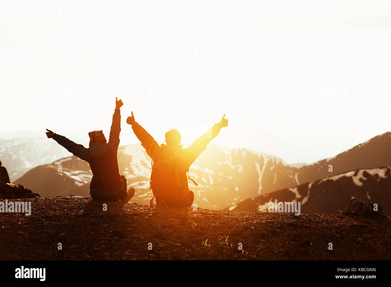 Happy couple friends having fun sunset mountain Stock Photo - Alamy