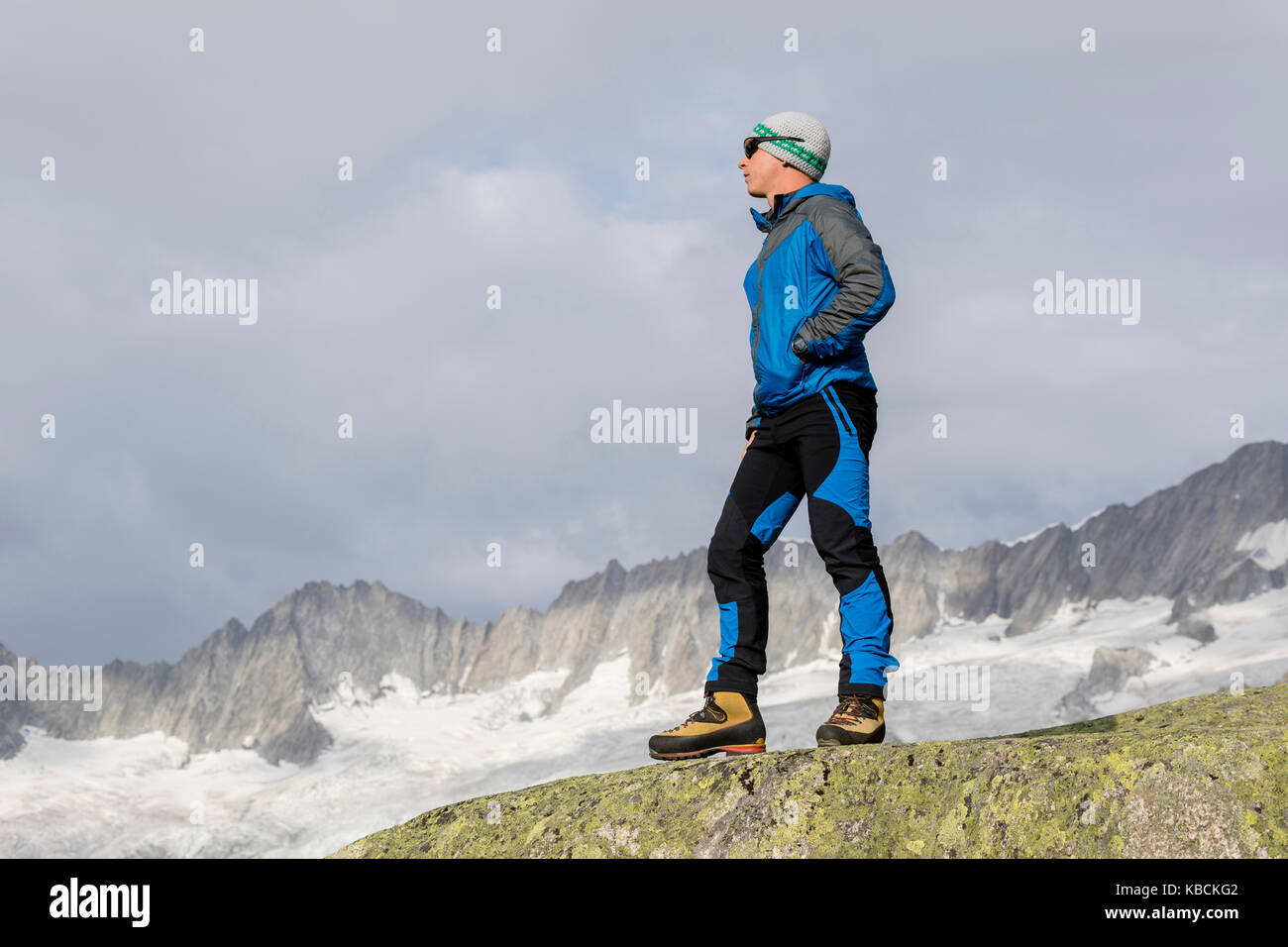 Hiker is thinking about the meaning of life in the Swiss Alps Stock ...