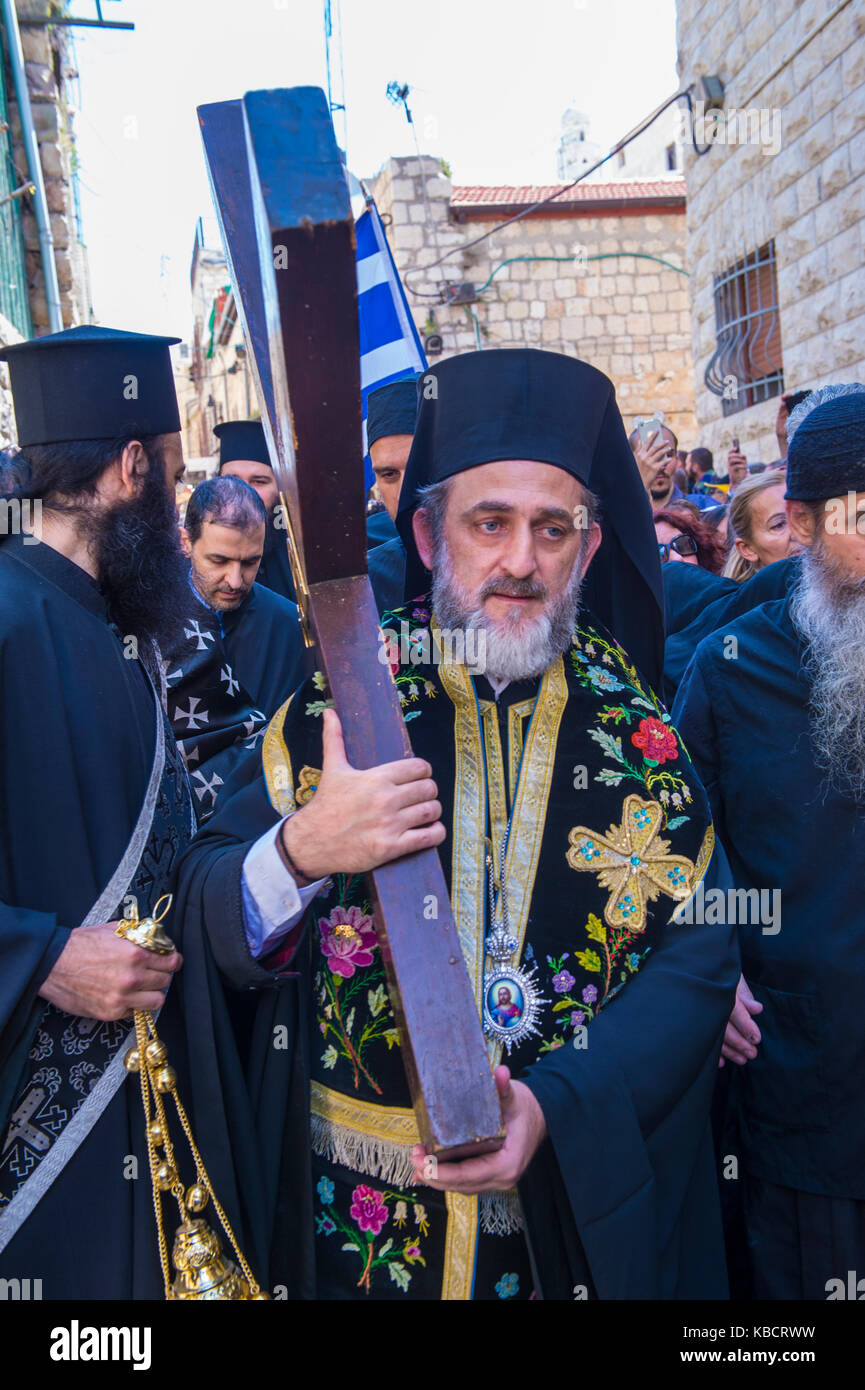 Christian pilgrim carry across along the Via Dolorosa in Jerusalem ...
