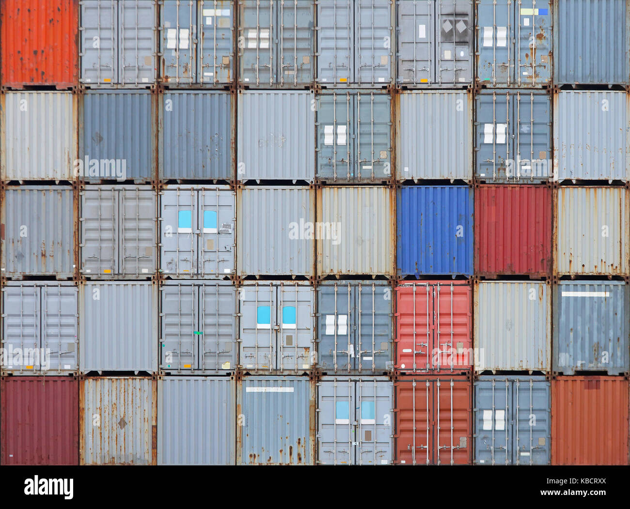 Stacked shipping containers at cargo terminal Stock Photo - Alamy