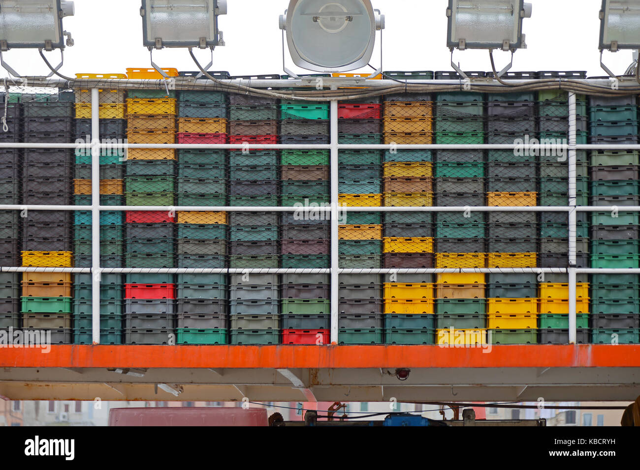 Colorful plastic fish boxes stacked at top of fishing vessel Stock ...