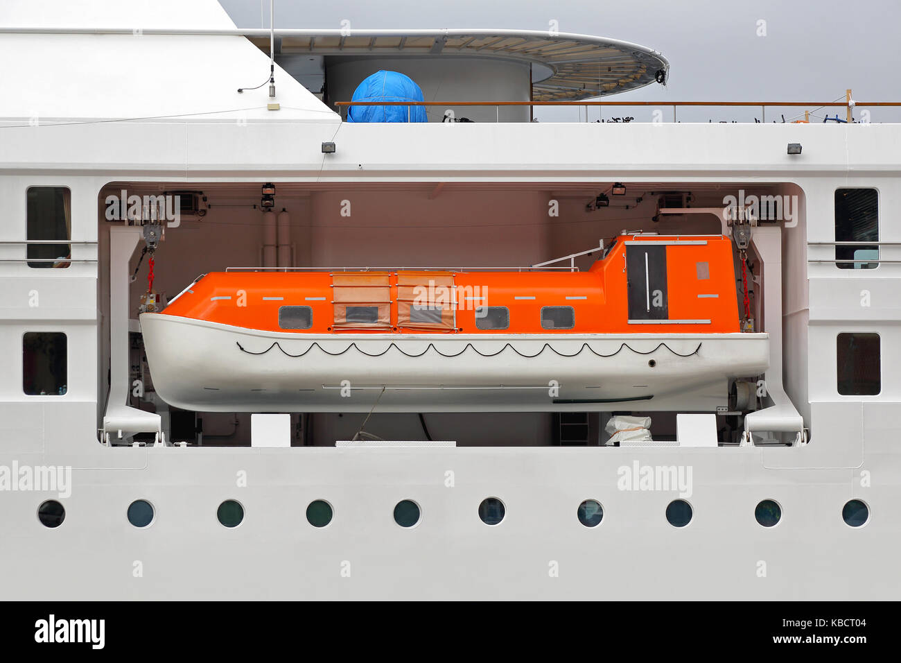 Enclosed lifeboat on a big cruise ship Stock Photo - Alamy